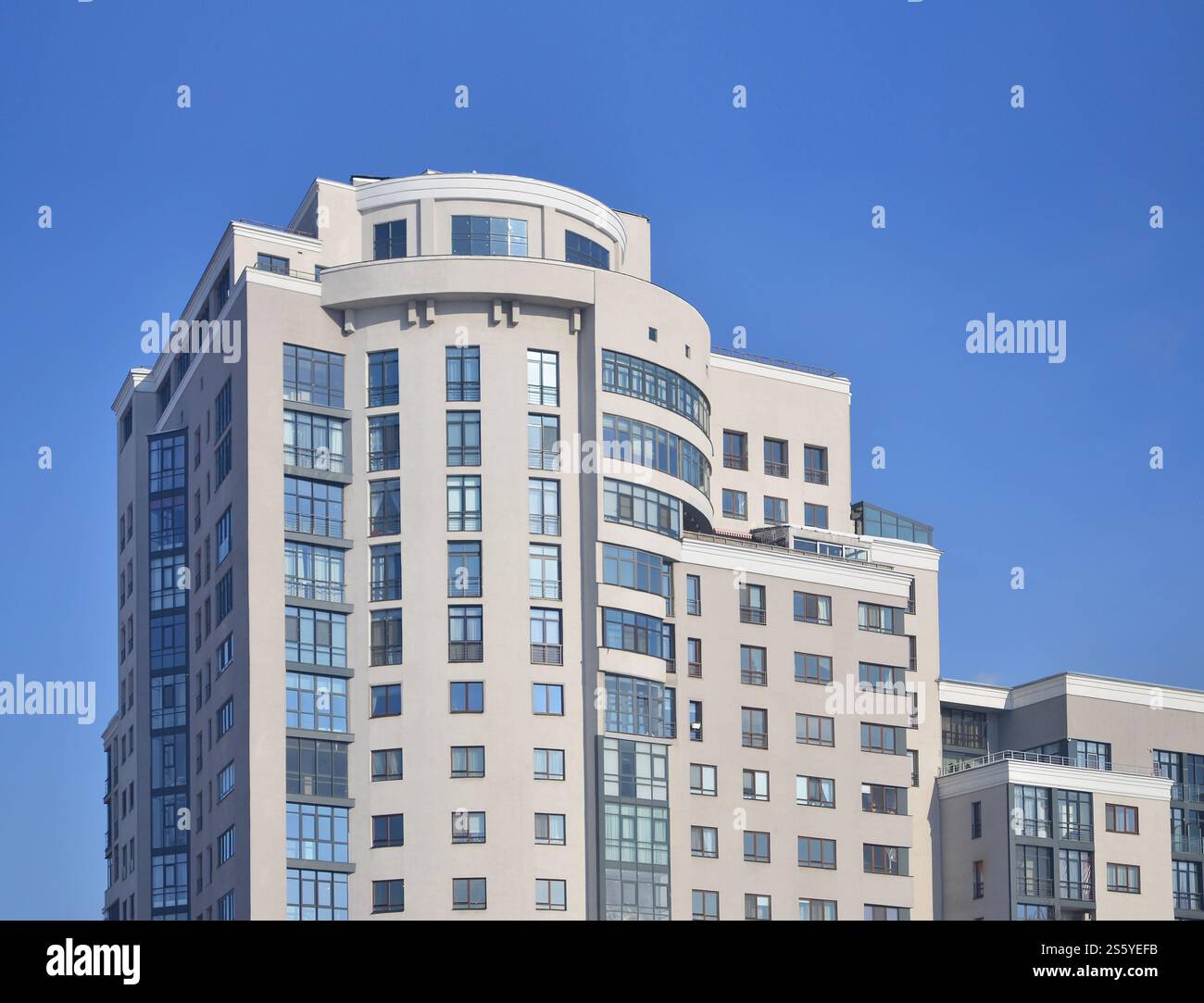 Multi-story office building beige color with lots of glass windows on a ...
