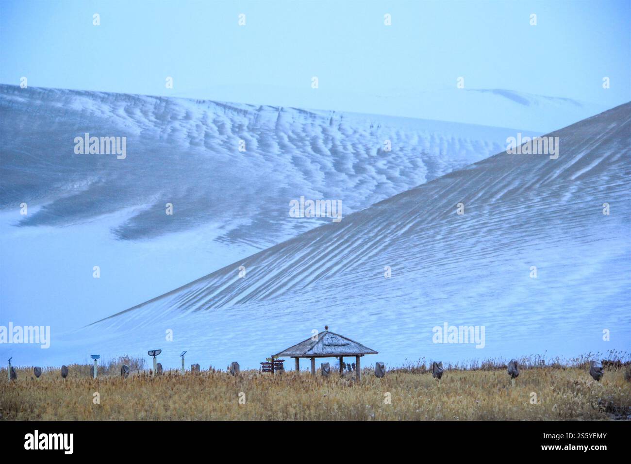 Tourists admire the snow scenery of the Mingsha Mountain and Yueya ...
