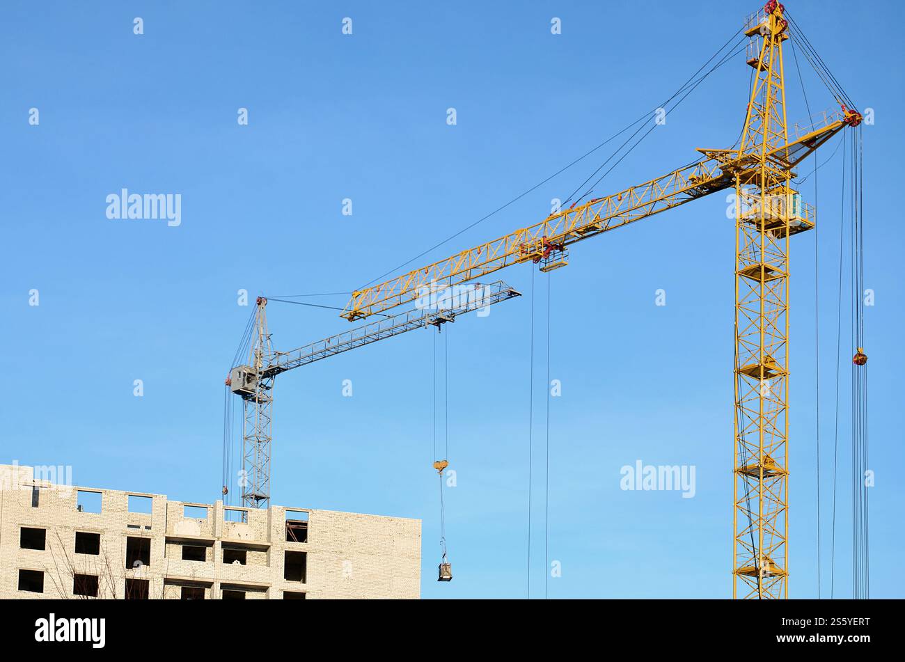 Working tall cranes inside place for with tall buildings under ...