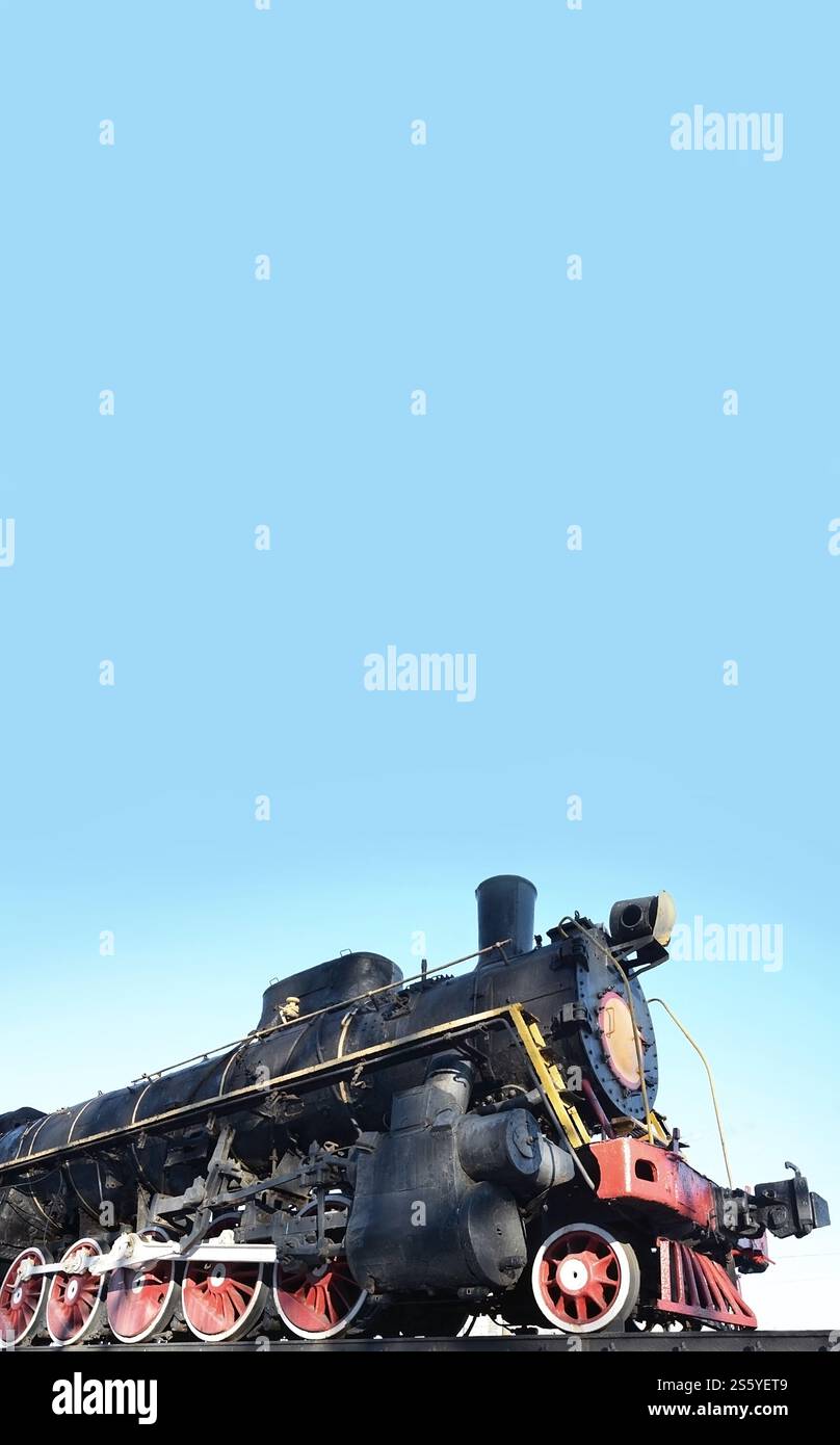 Antique black retro-train on track. A monument to the industrial ...