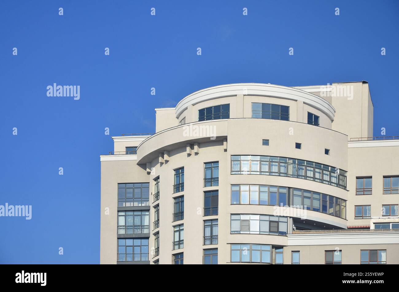 Multi-story office building beige color with lots of glass windows on a ...