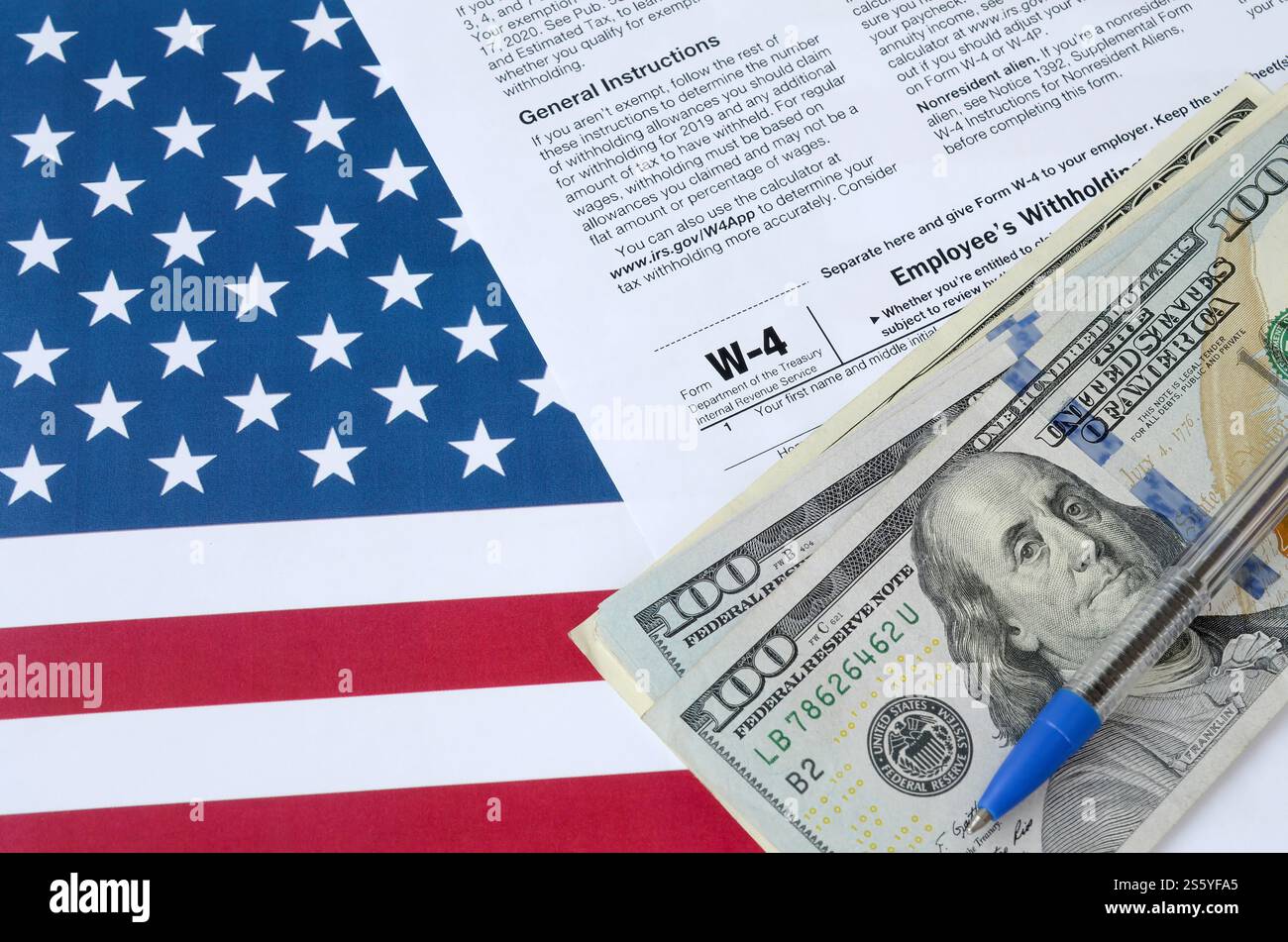 Form W-4 Employees withholding allowance certificate and blue pen with ...