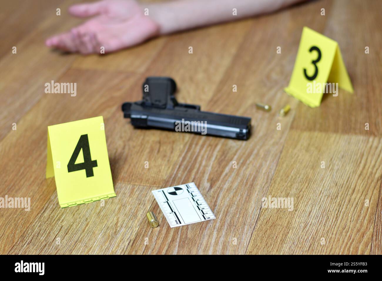 Hand of young man and gun with gunshells on wooden floor. Committed ...