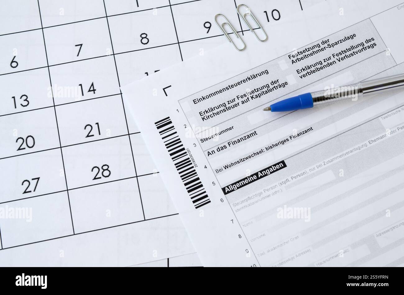 German tax form with pen lies on office calendar. Concept of annual tax ...