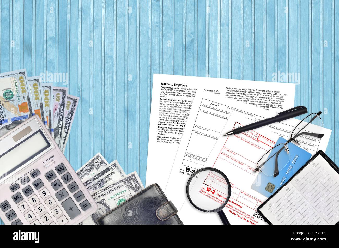 IRS form W-2 wage and tax statement lies on flat lay office table and ...