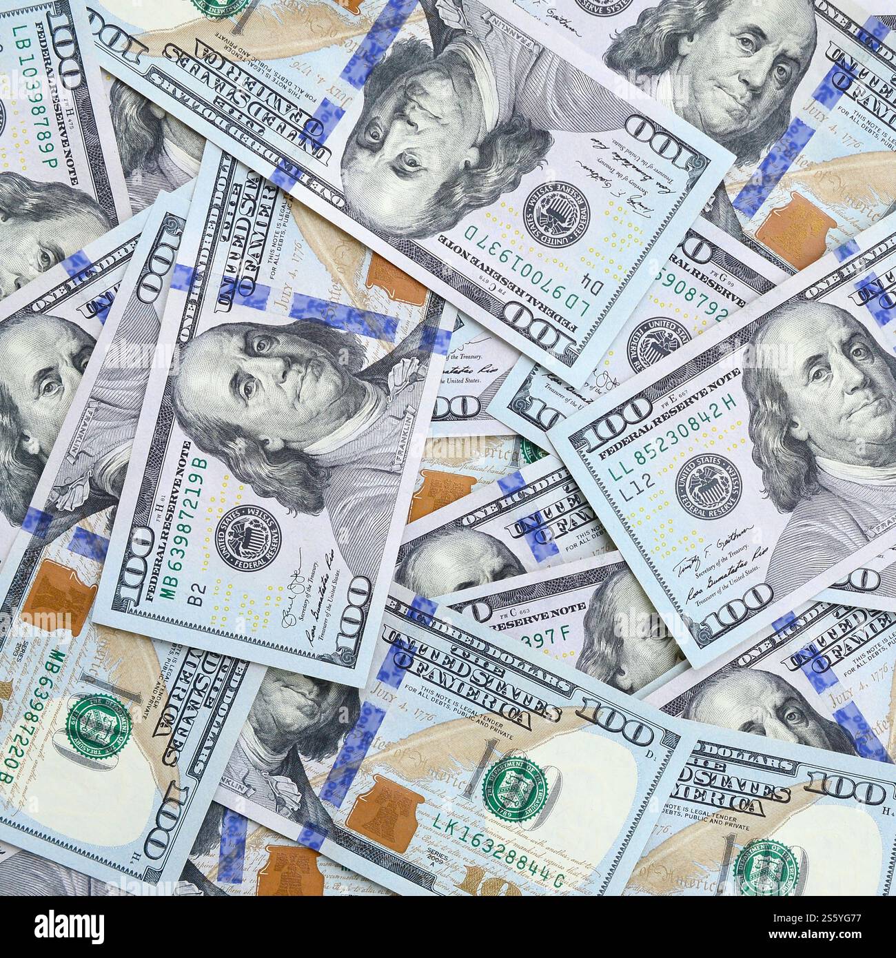 A large number of US dollar bills of a new design with a blue stripe in ...