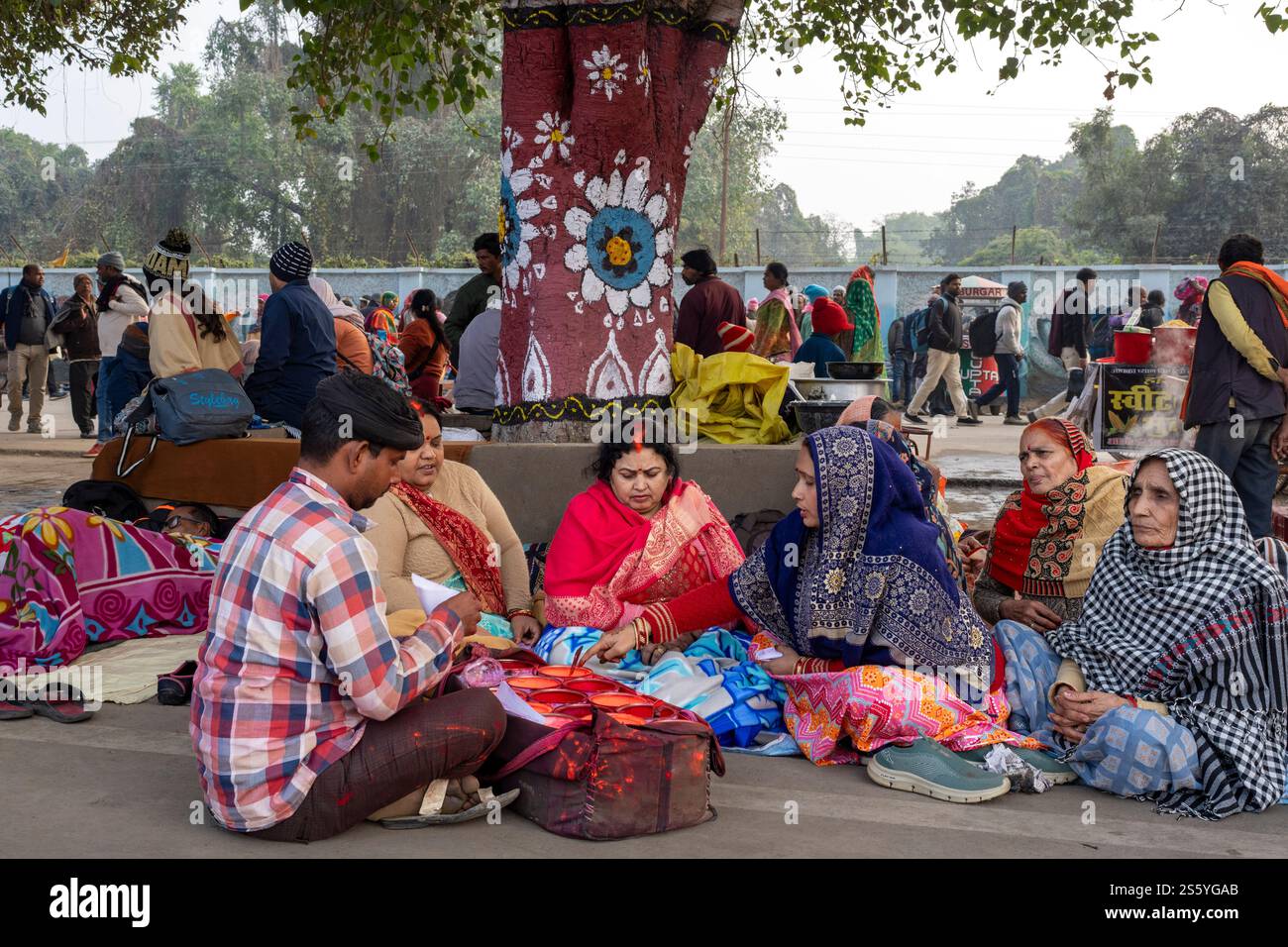 Hindu pilgrims from New Delhi buy vermillion powder as they rest under ...