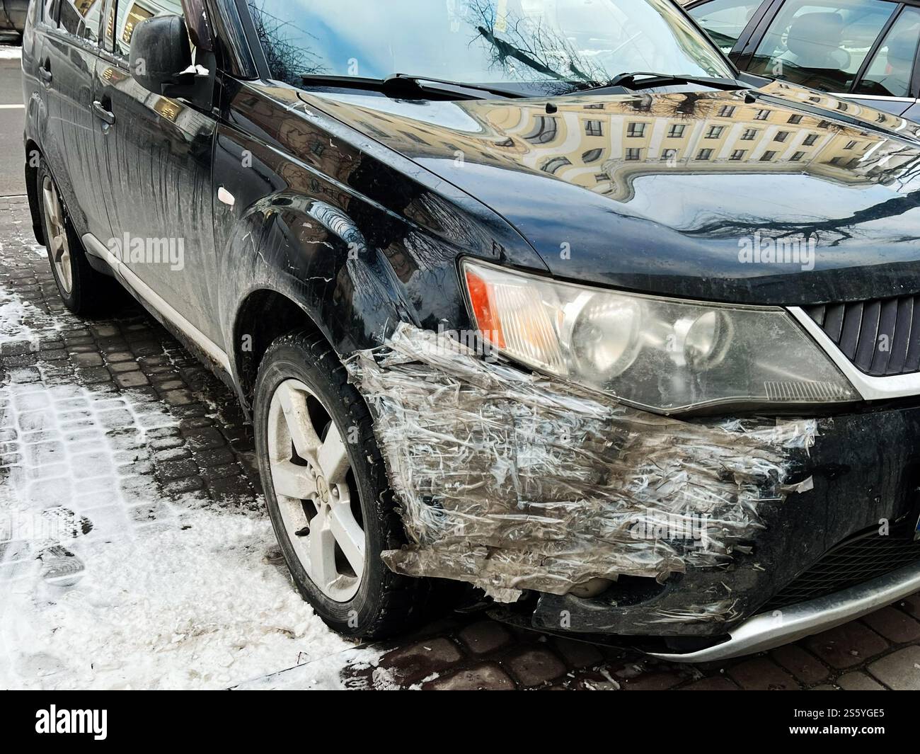 Kyiv, Ukraine - January 14, 2025: A black car with visible damage to ...