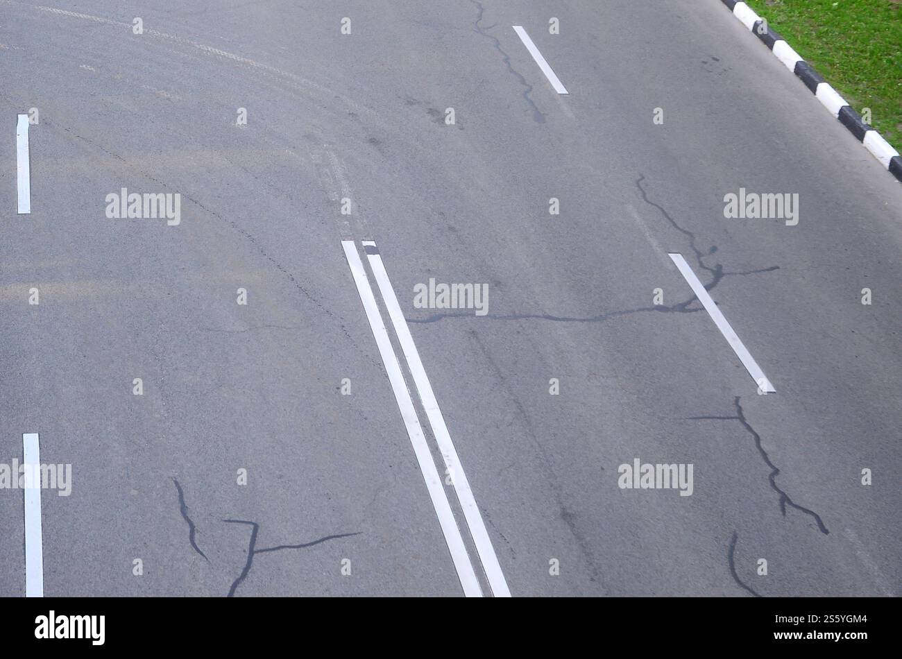 Damaged bad asphalt road with potholes. Patch repair of asphalt. Bad ...