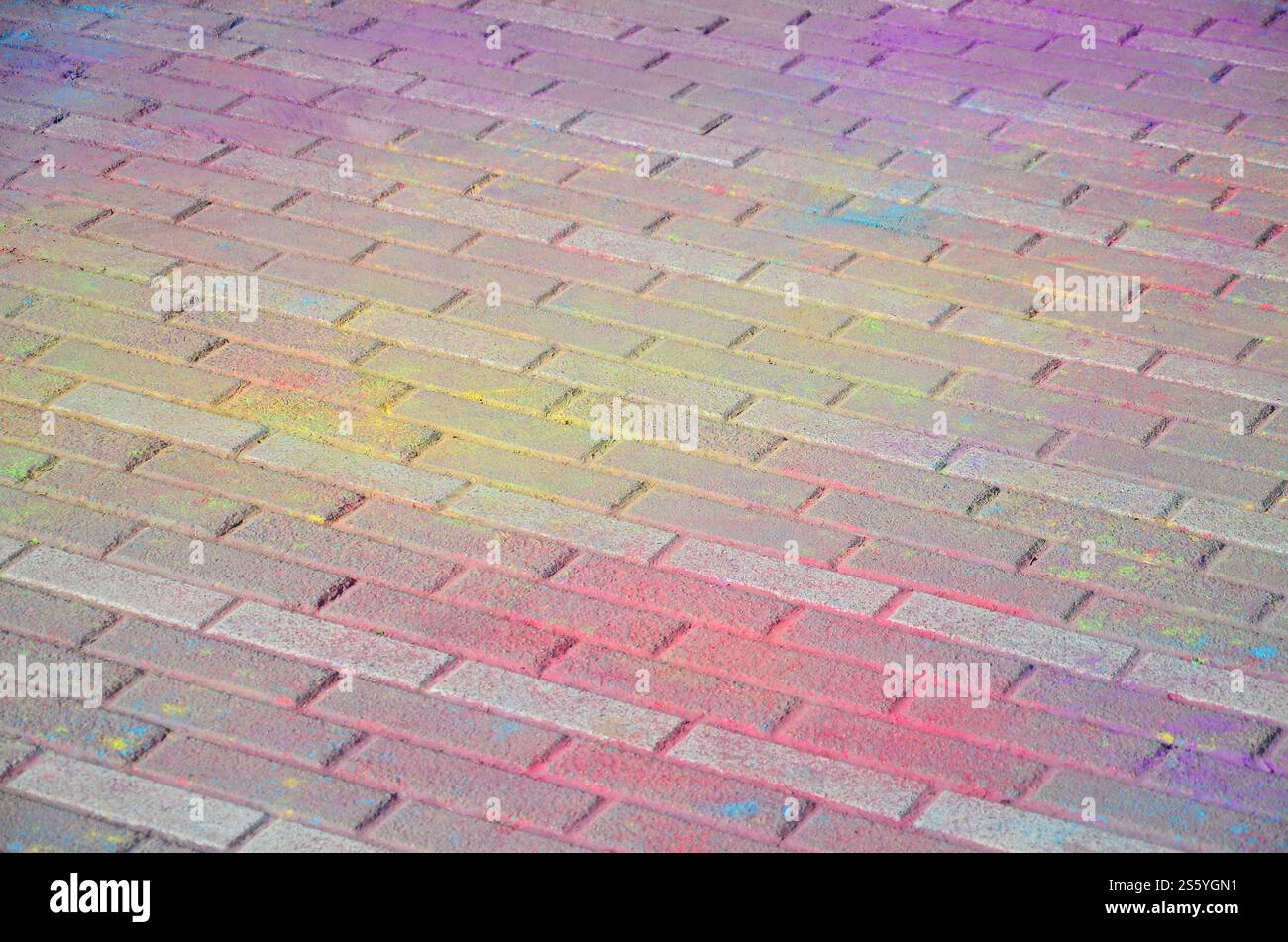 Multi colored earth, paving slabs, powder coated with dry colors at the Holi festival close up ...