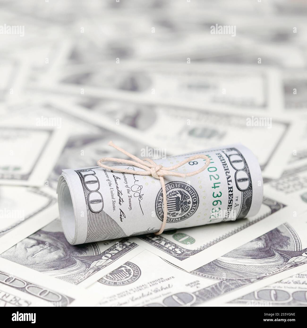 US dollars rolled up and tightened with band lies on a lot of american ...