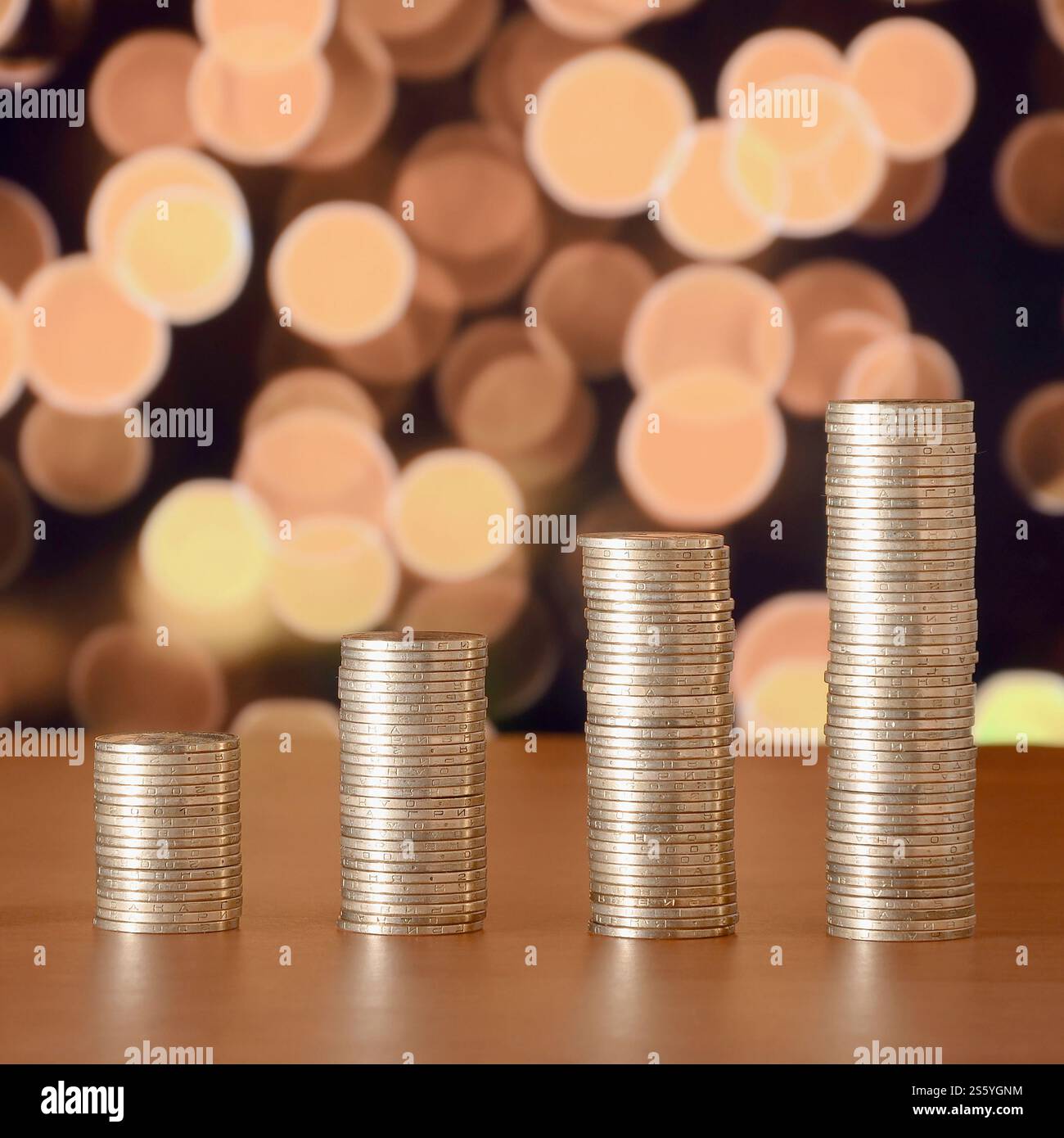 Golden coin stacks arranged as a graph. Increasing columns of coins ...