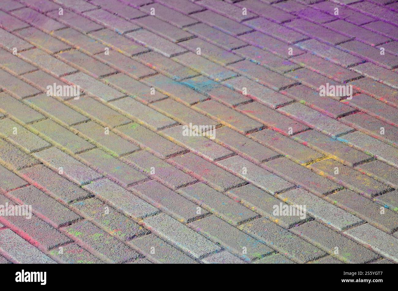 Multi colored earth, paving slabs, powder coated with dry colors at the Holi festival close up ...
