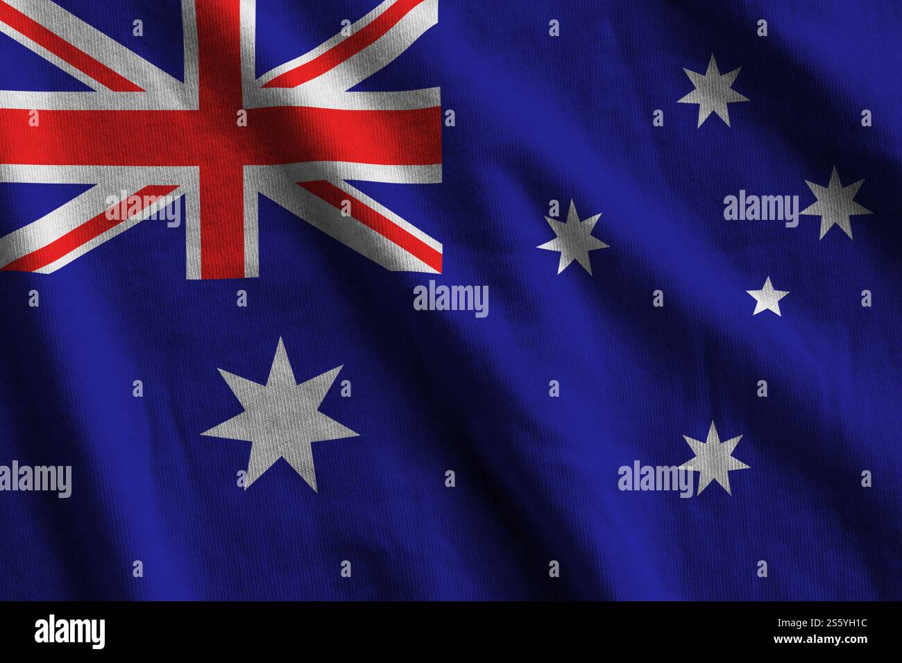 Australia flag with big folds waving close up under the studio light ...