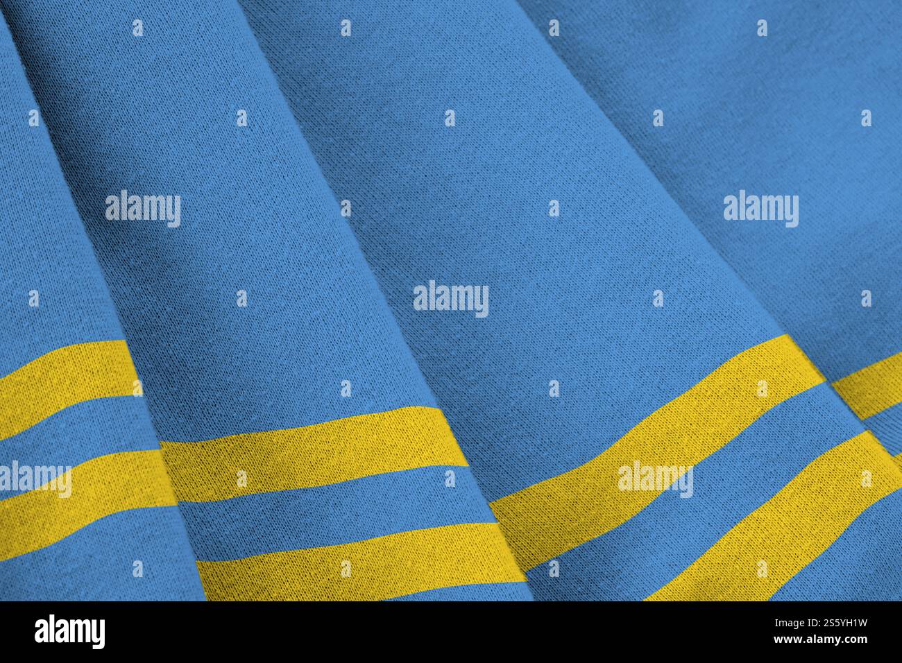 Aruba flag with big folds waving close up under the studio light ...