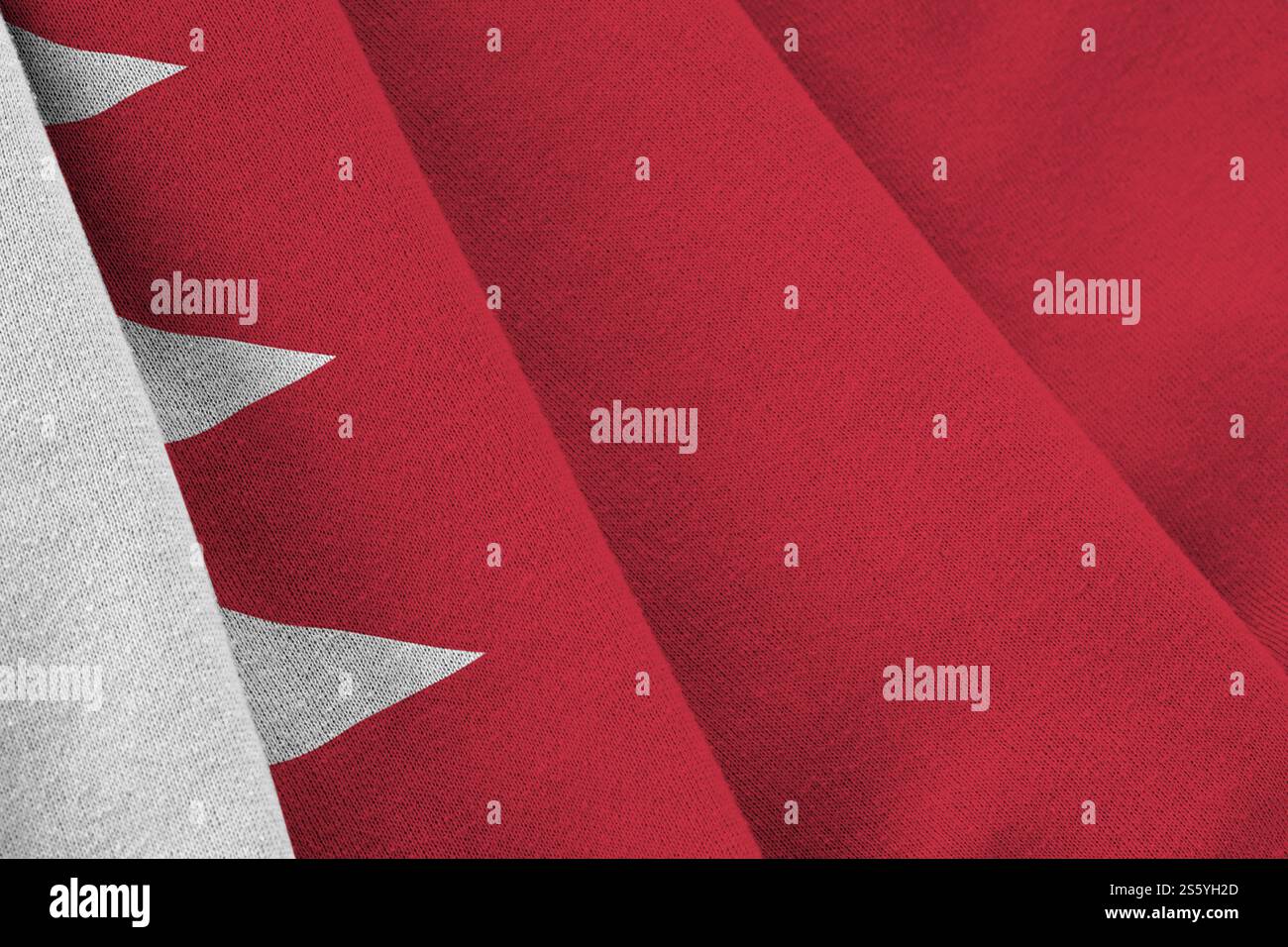 Bahrain flag with big folds waving close up under the studio light ...