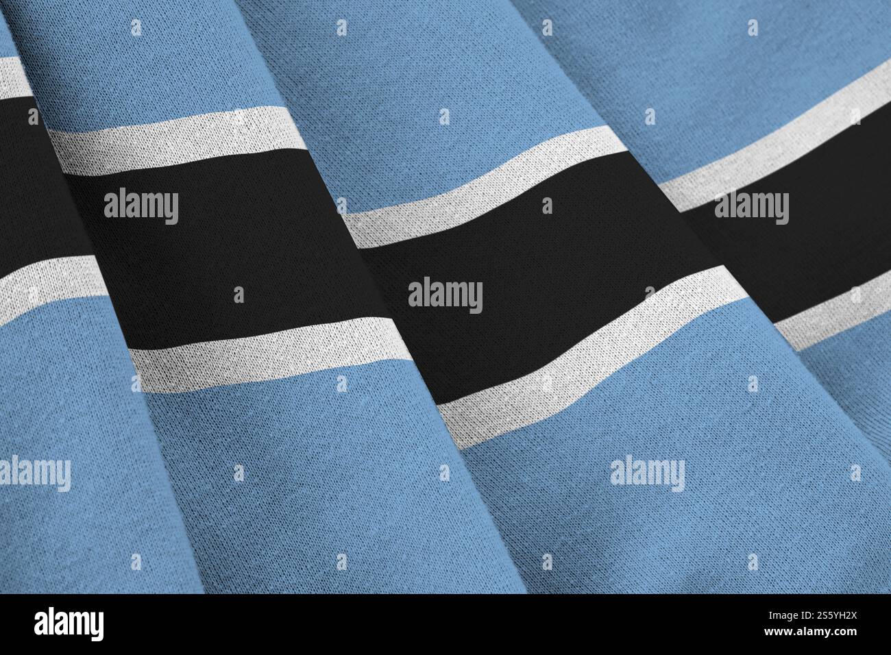 Botswana flag with big folds waving close up under the studio light ...