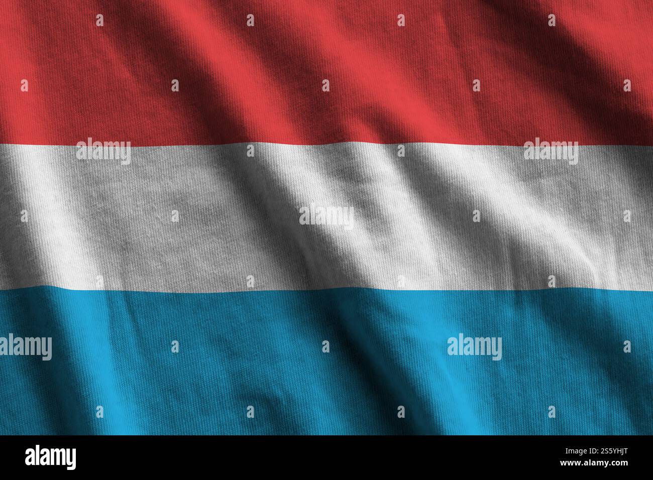Luxembourg flag with big folds waving close up under the studio light ...