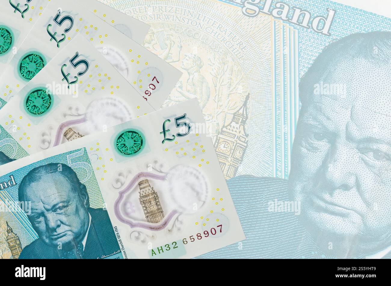 5 British pounds bills lies in stack on background of big semi ...