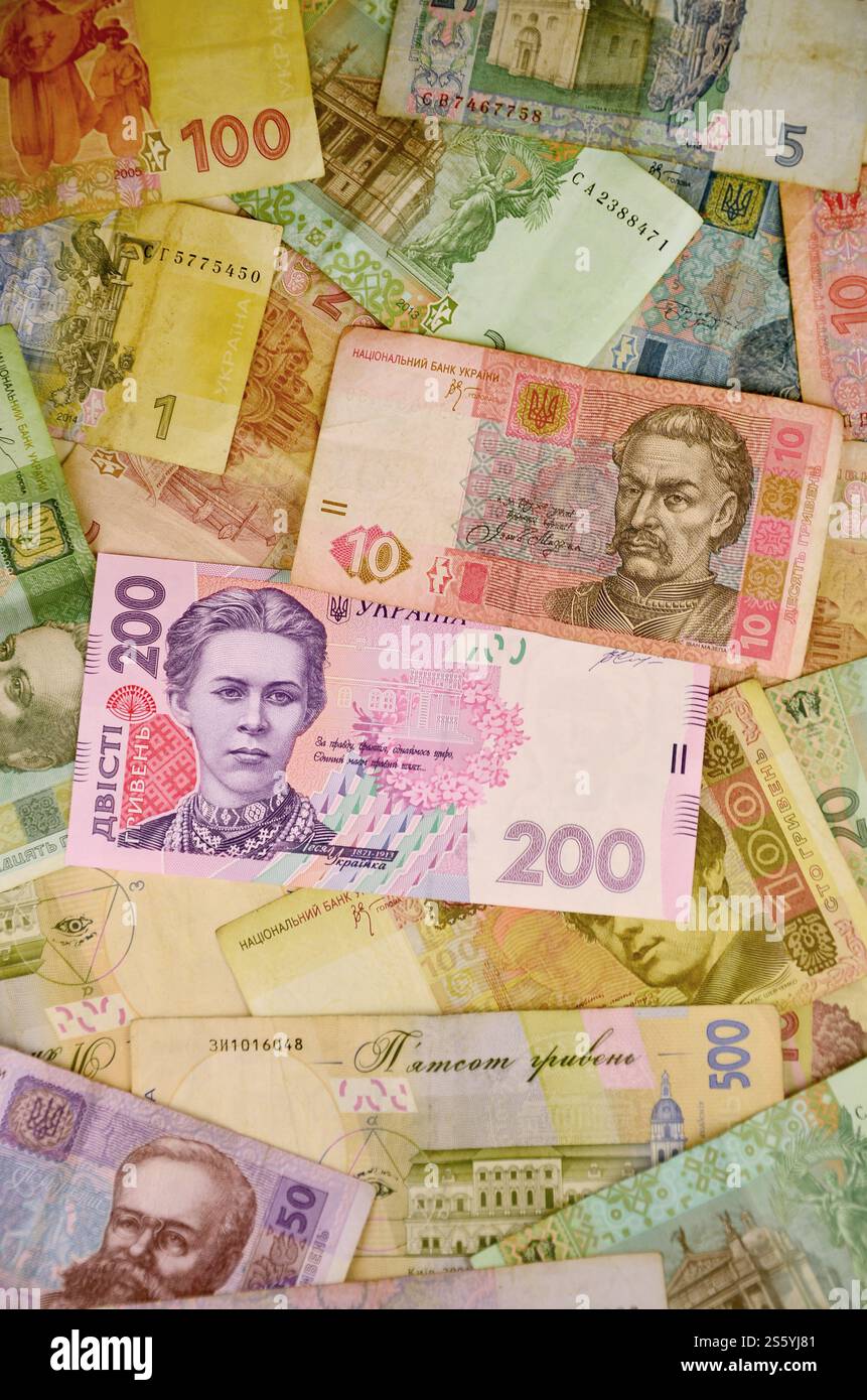 Background image of many Ukrainian banknotes of different colors and ...