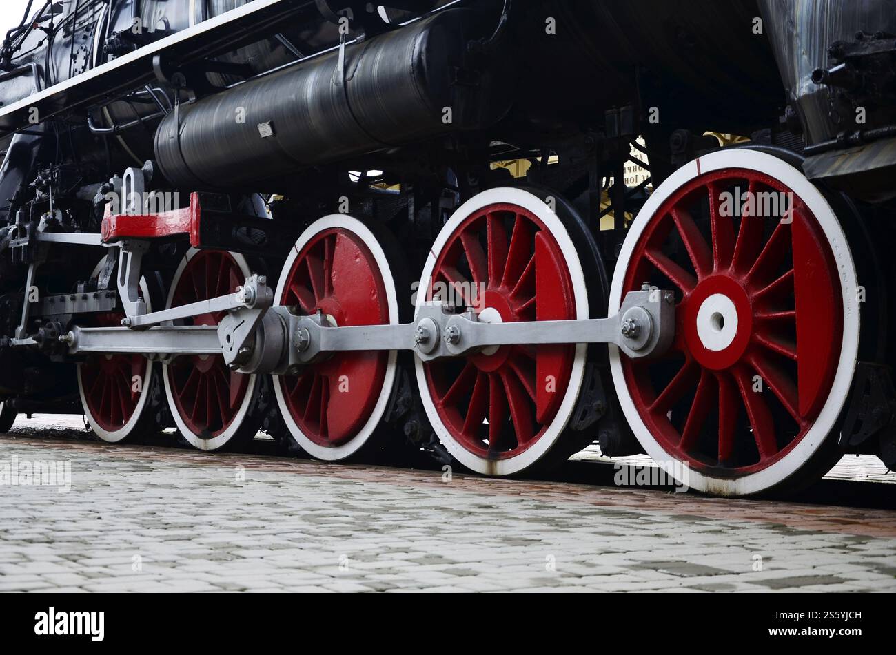 Red wheels of old USSR black steam locomotive. Wheels of an old soviet ...