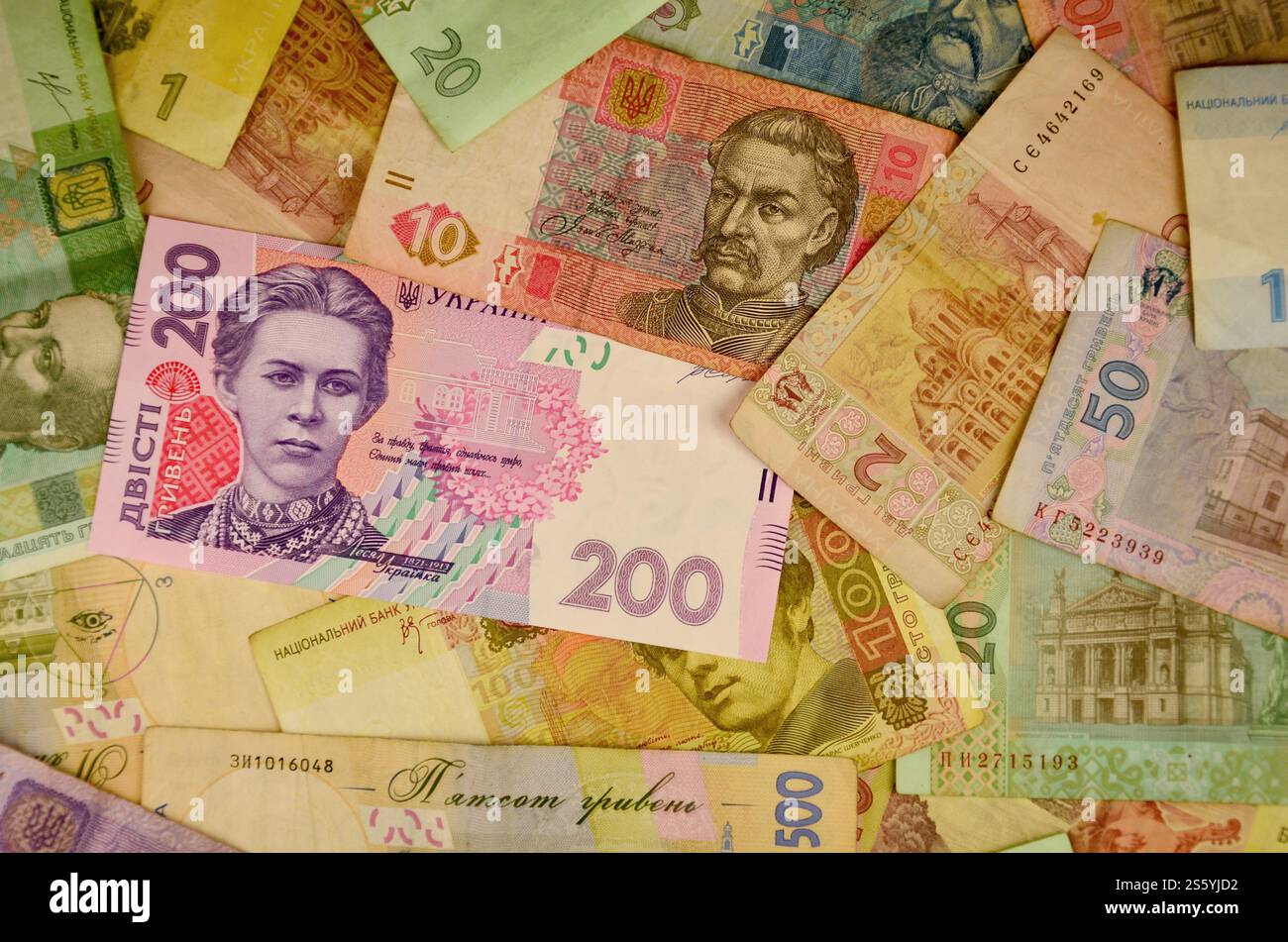 Background image of many Ukrainian banknotes of different colors and ...