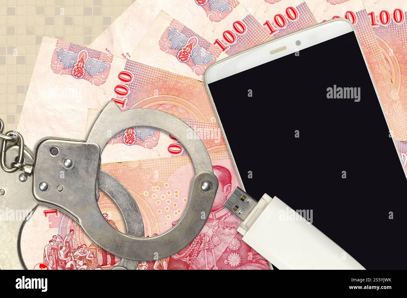 100 Thai Baht bills and smartphone with police handcuffs. Concept of ...
