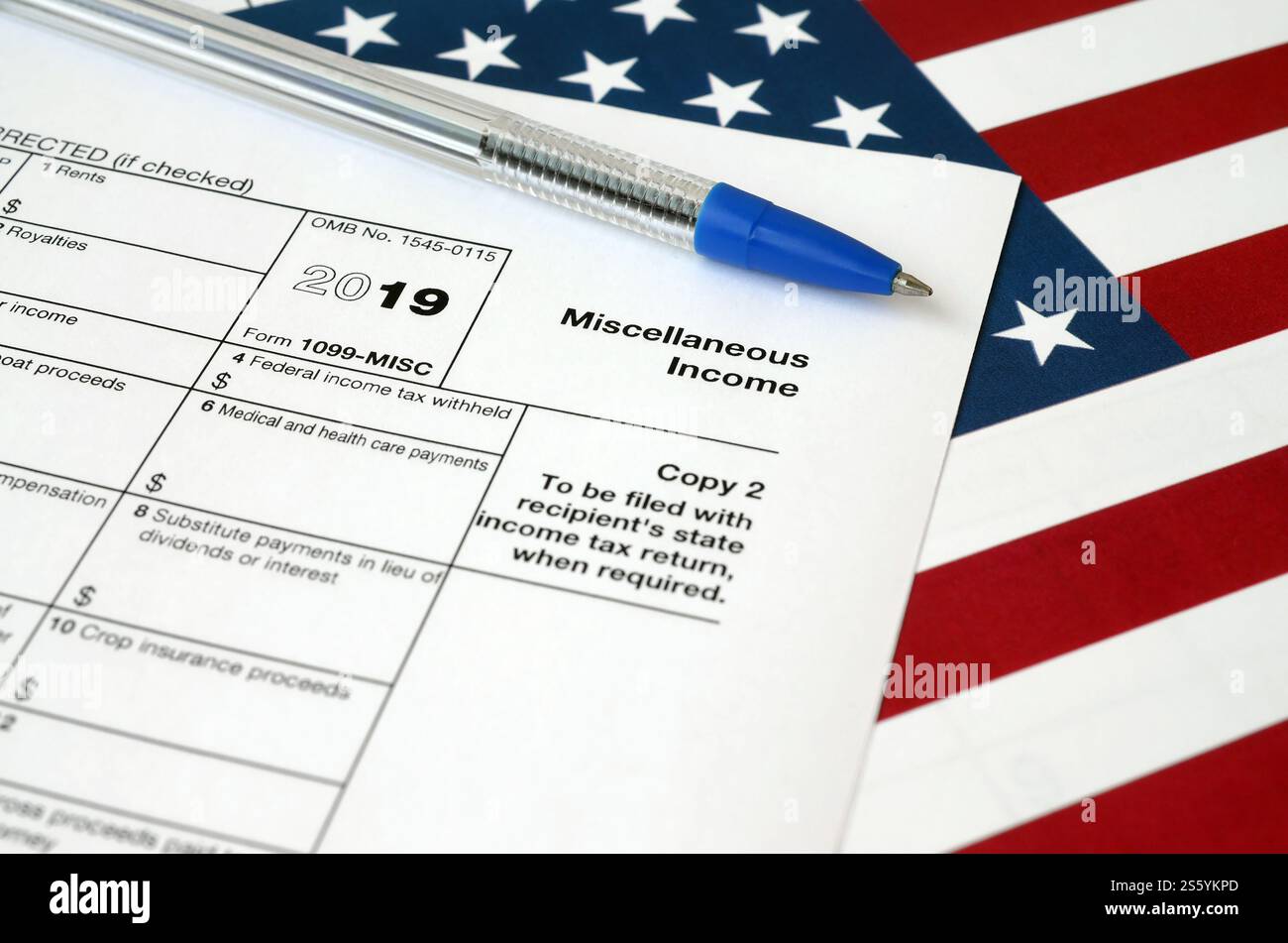 Form 1099-misc Miscellaneous income and blue pen on United States flag ...