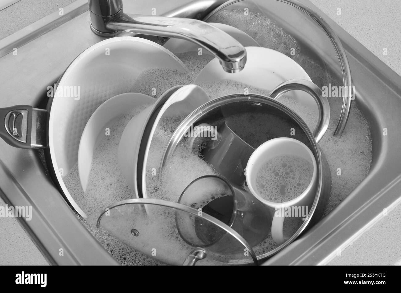 Dirty dishes and unwashed kitchen appliances filled the kitchen sink ...