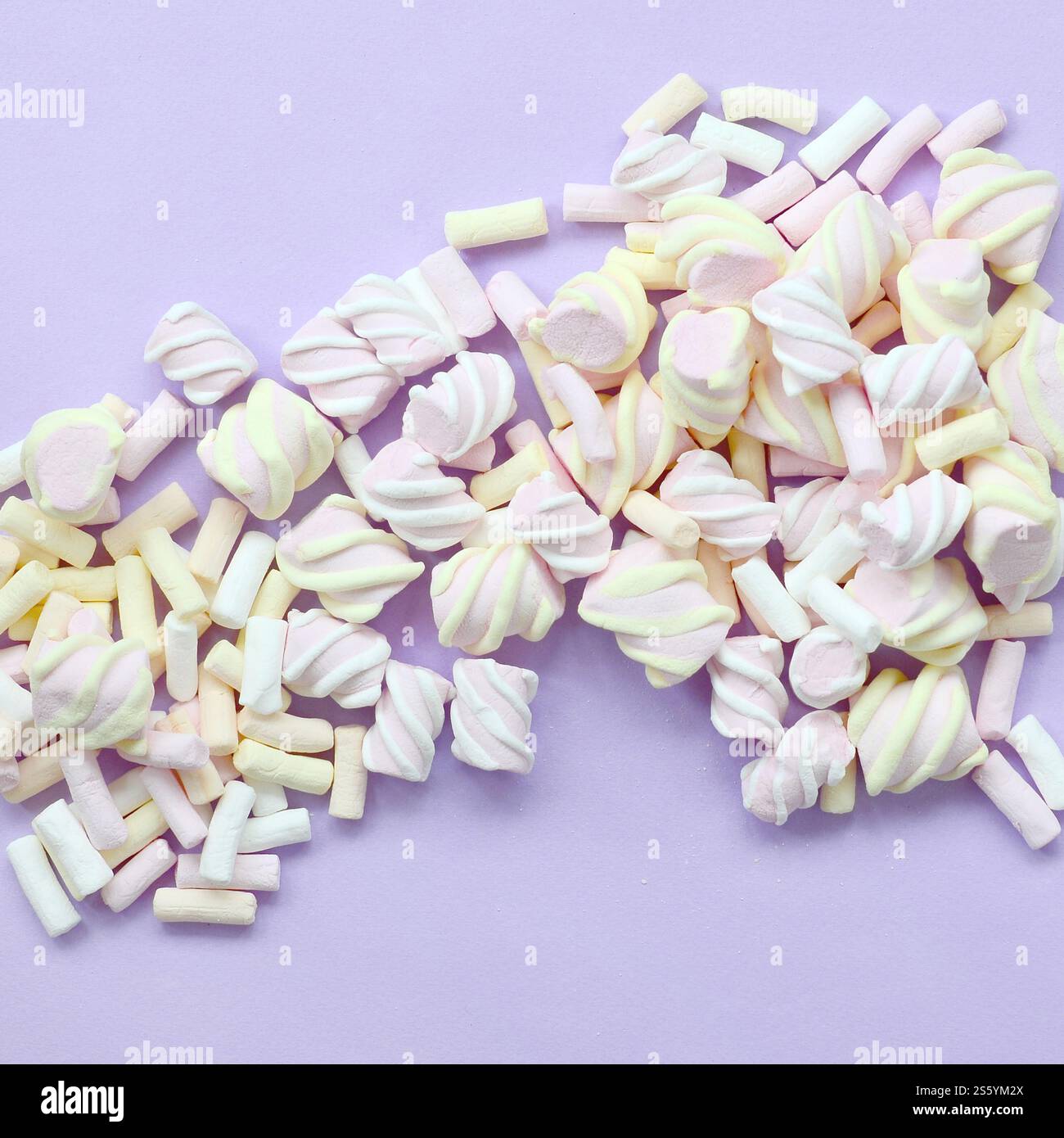 Colorful marshmallow laid out on violet paper background. pastel ...