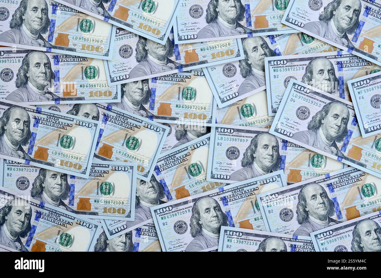 A large number of US dollar bills of a new design with a blue stripe in ...