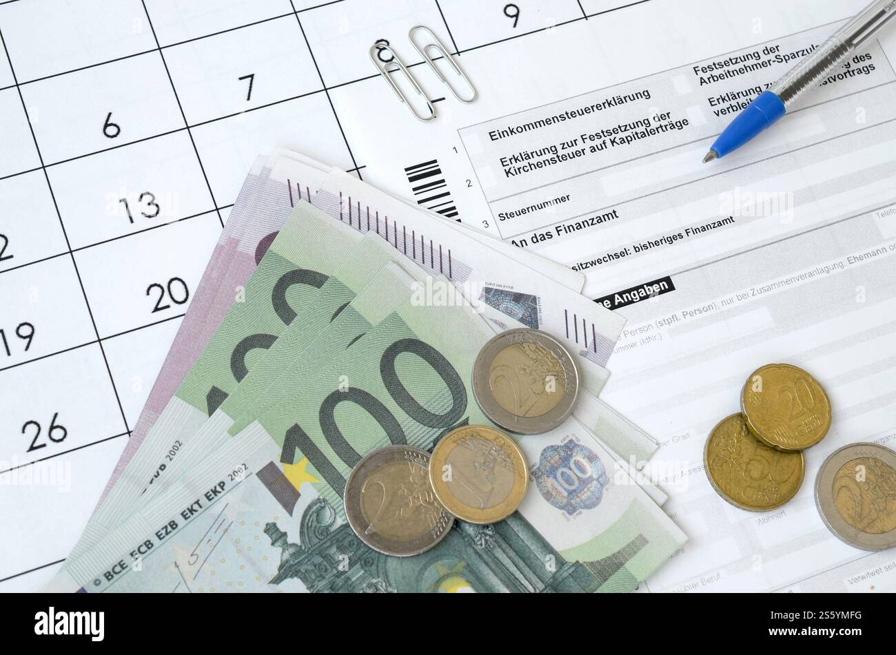 German tax form with pen and european money bills lies on office ...