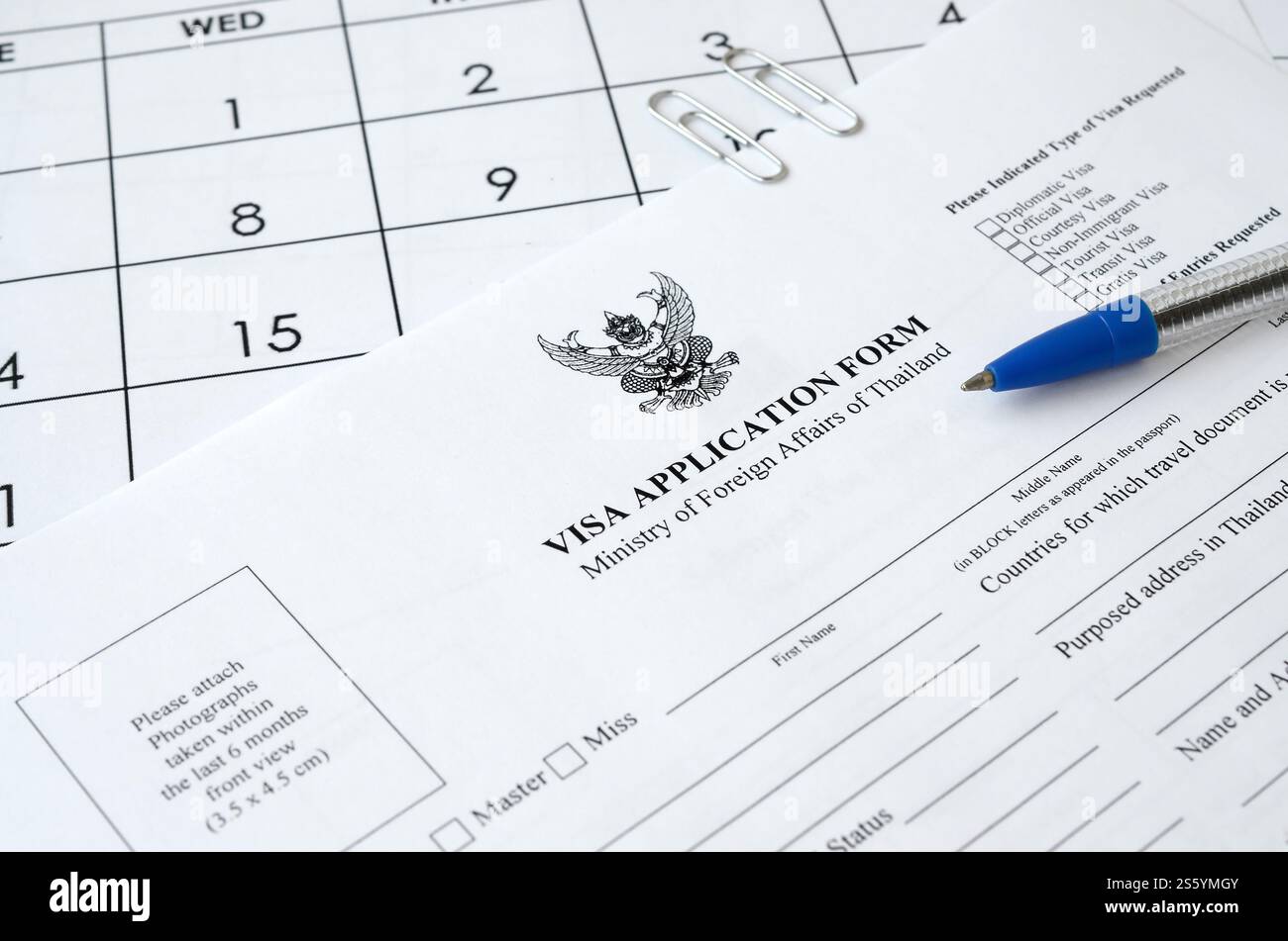Thailand Visa application form and blue pen on paper calendar page ...
