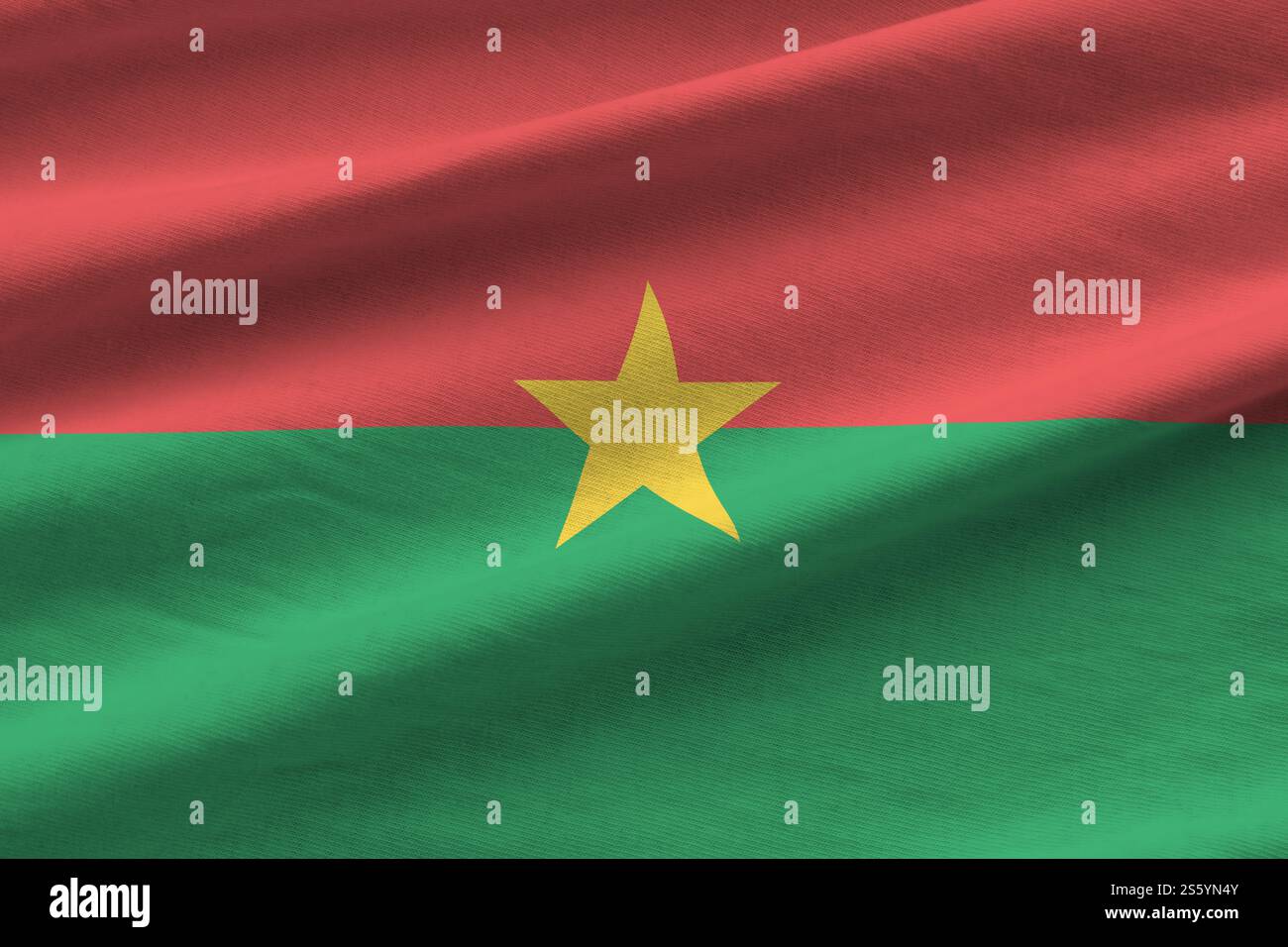Burkina Faso flag with big folds waving close up under the studio light ...