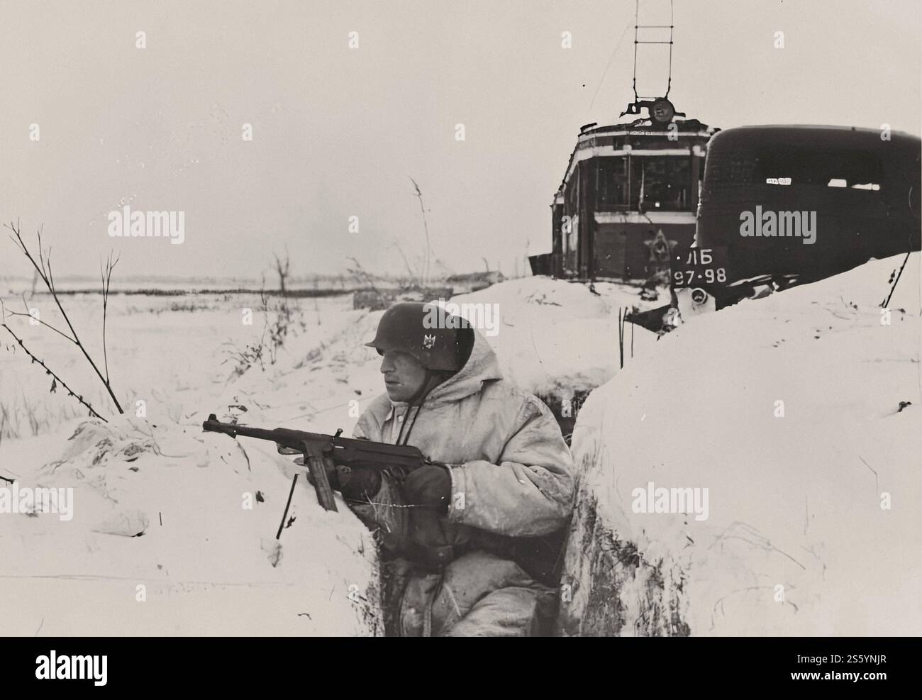 A German soldier with MP-38 - 40 near an abandoned Soviet GAZ-M1 and ...