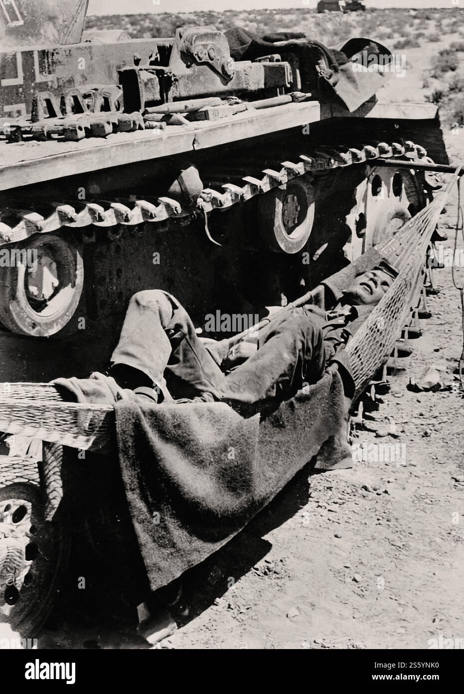 a Soldier of the Panzerwaffe resting in a hammock that is attached to a ...