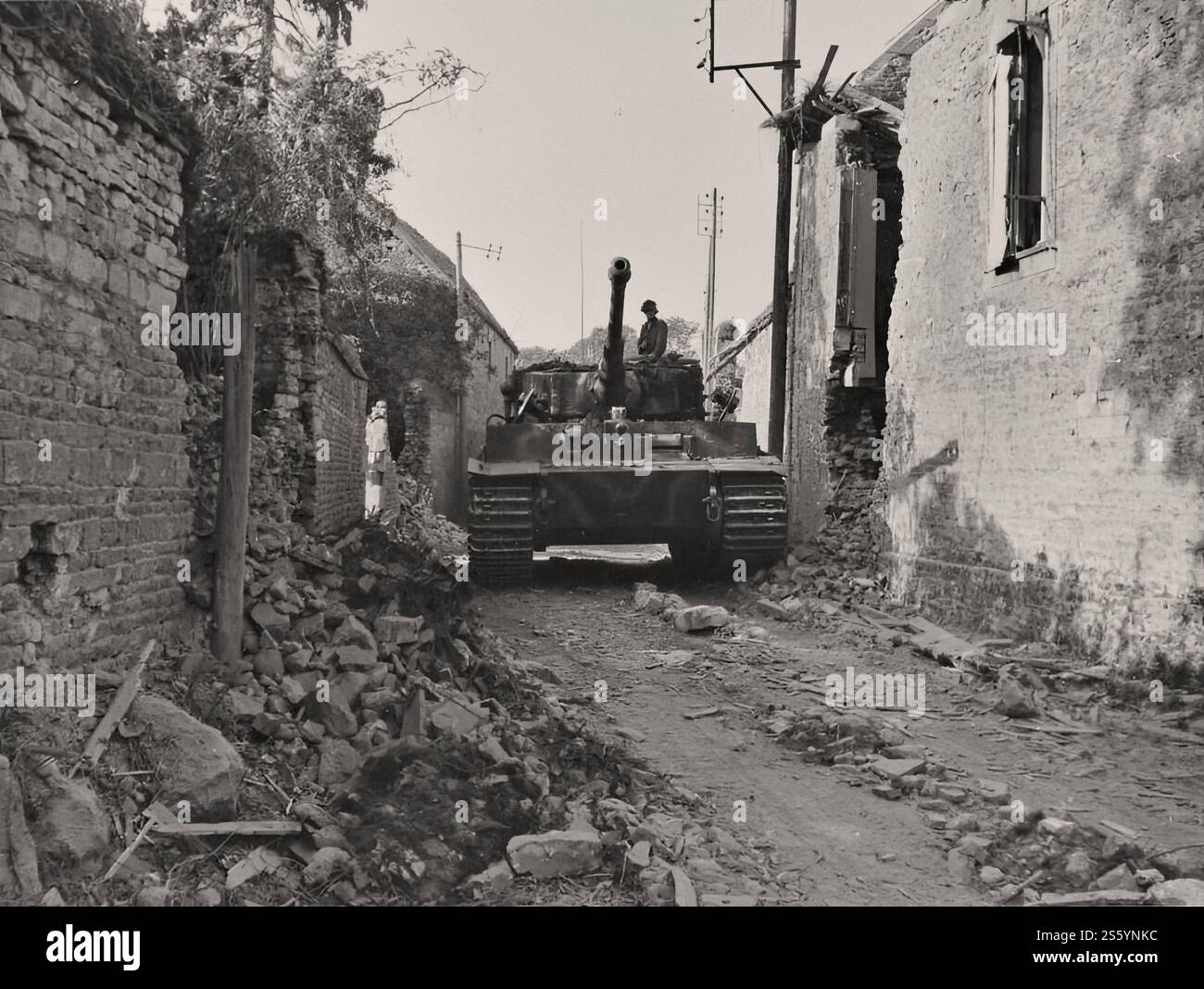 A Tiger tank of schwere SS-Panzer-Abteilung 101 moves through a French ...