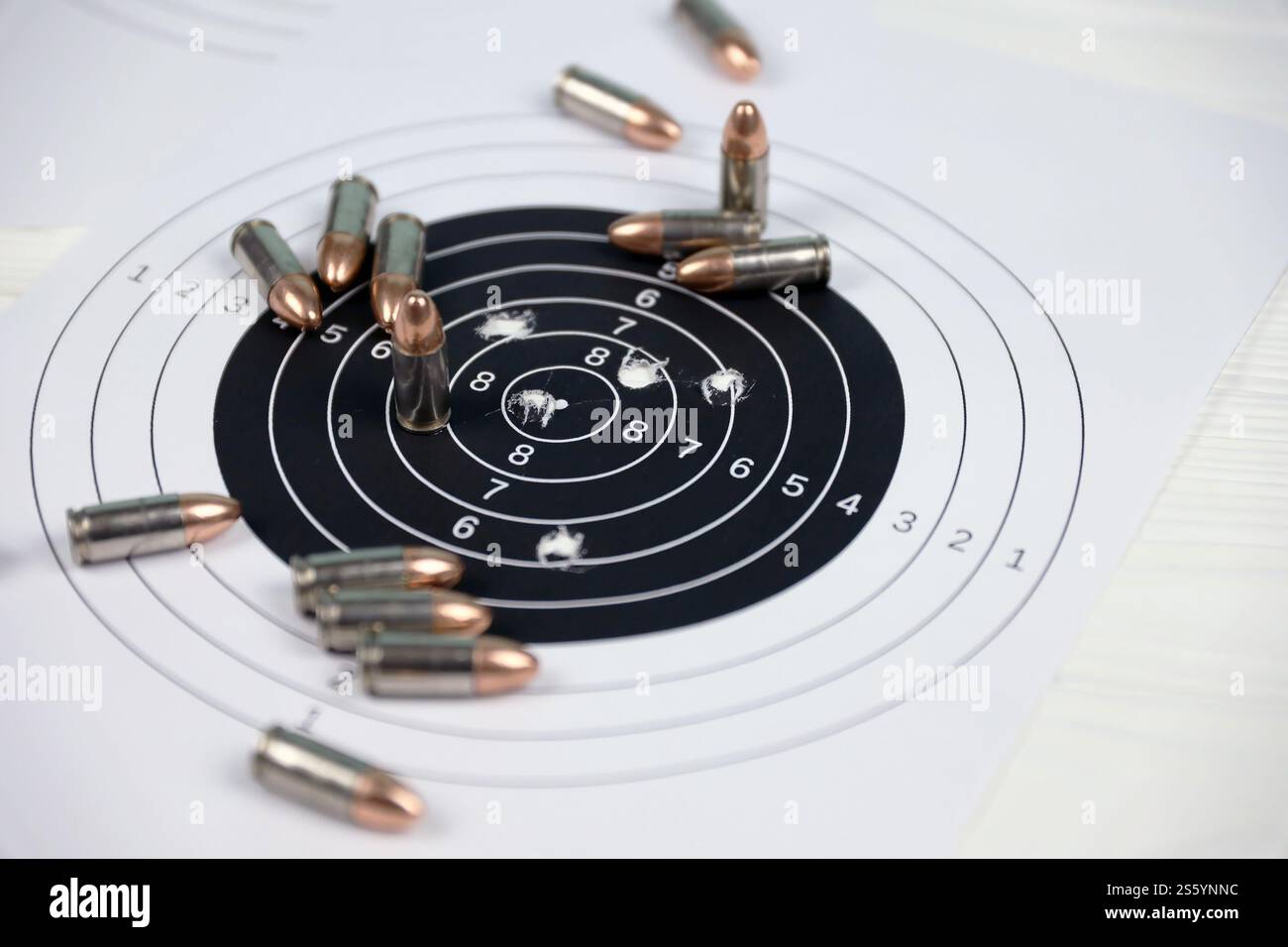 Many bullets with shooting targets on white table in shooting range ...