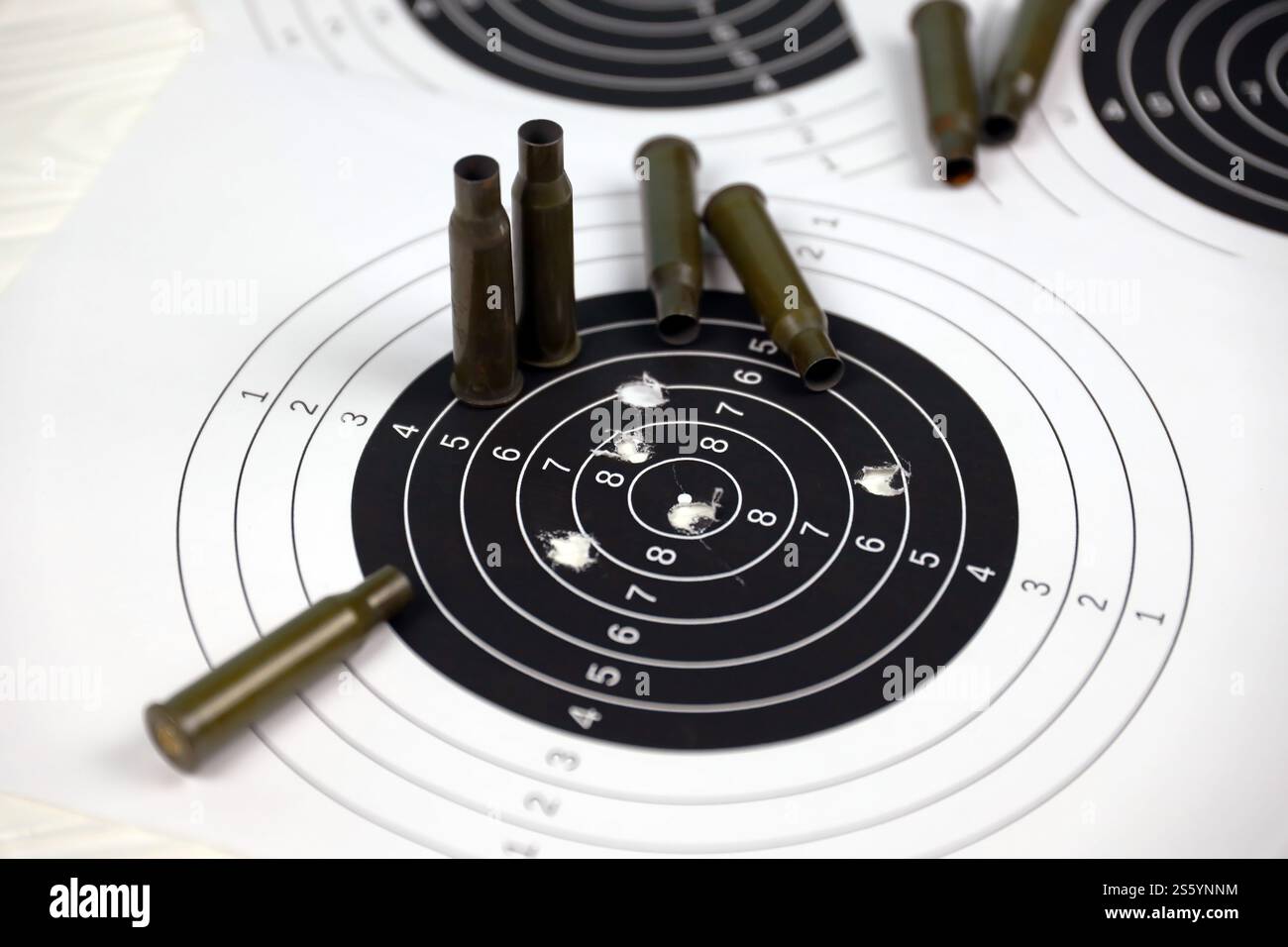 Many bullets with shooting targets on white table in shooting range ...