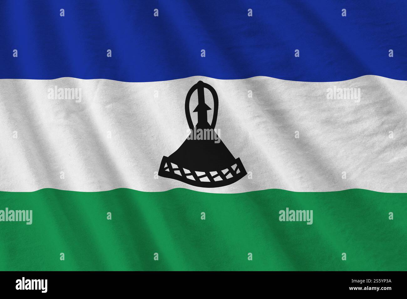 Lesotho flag with big folds waving close up under the studio light ...