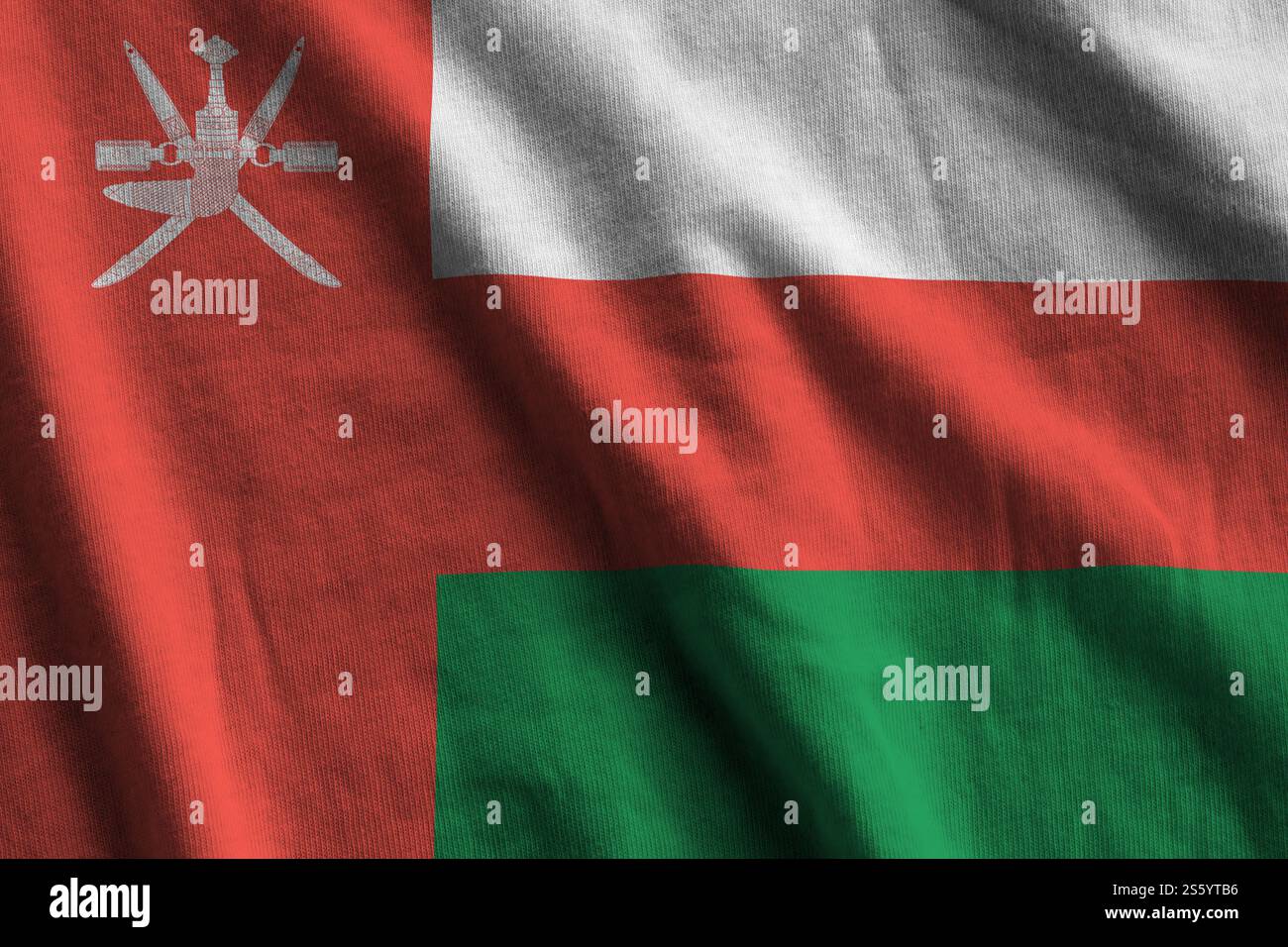 Oman flag with big folds waving close up under the studio light indoors ...