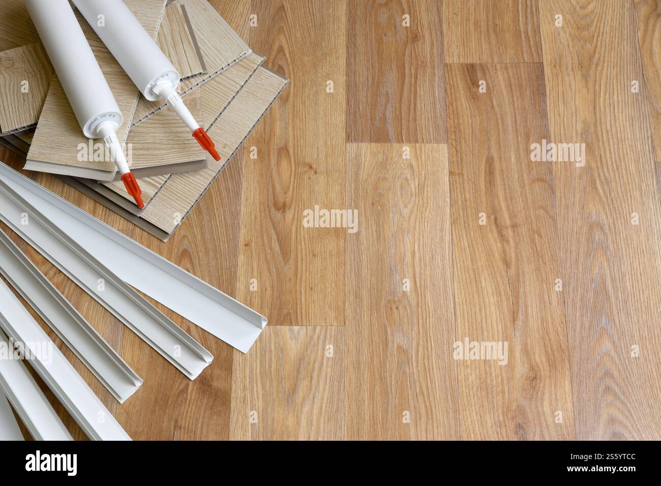 Set of items for PVC ceiling indoor works. Assembly adhesive bottles and PVC panels with plastic ...