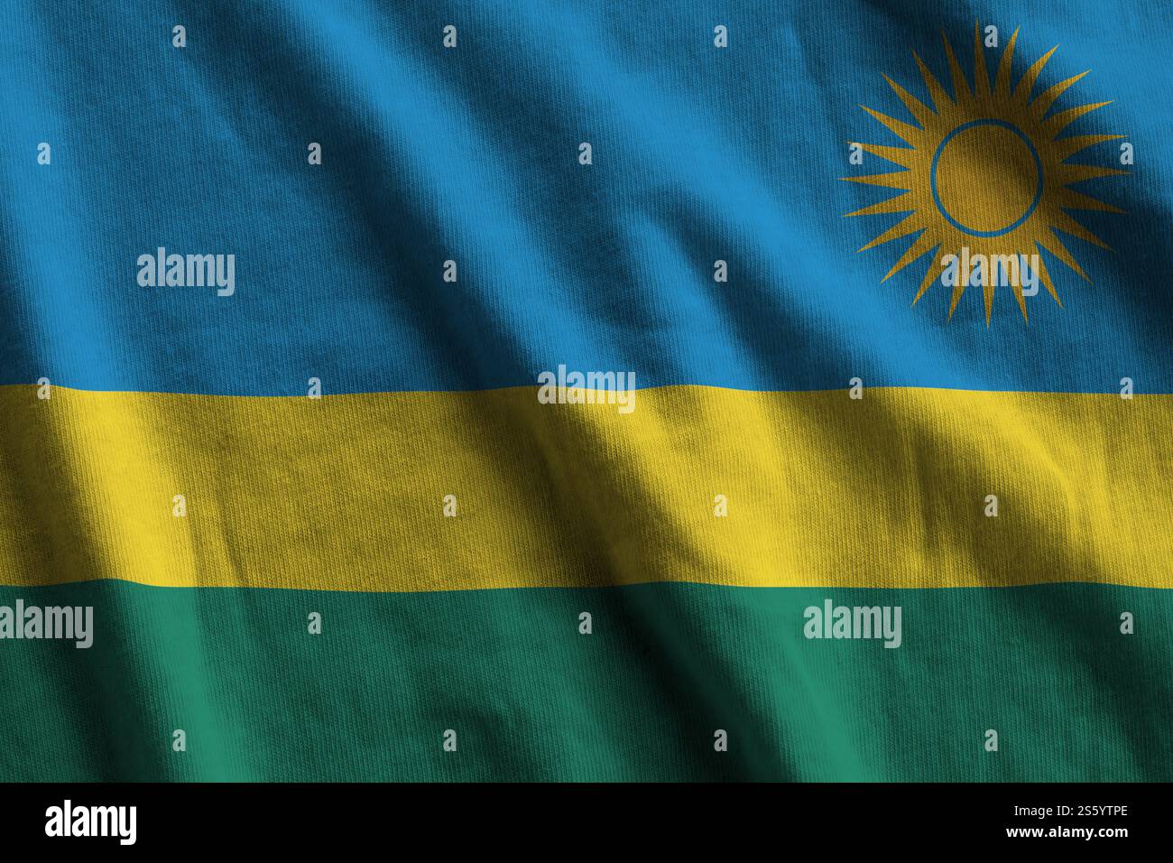 Rwanda flag with big folds waving close up under the studio light ...