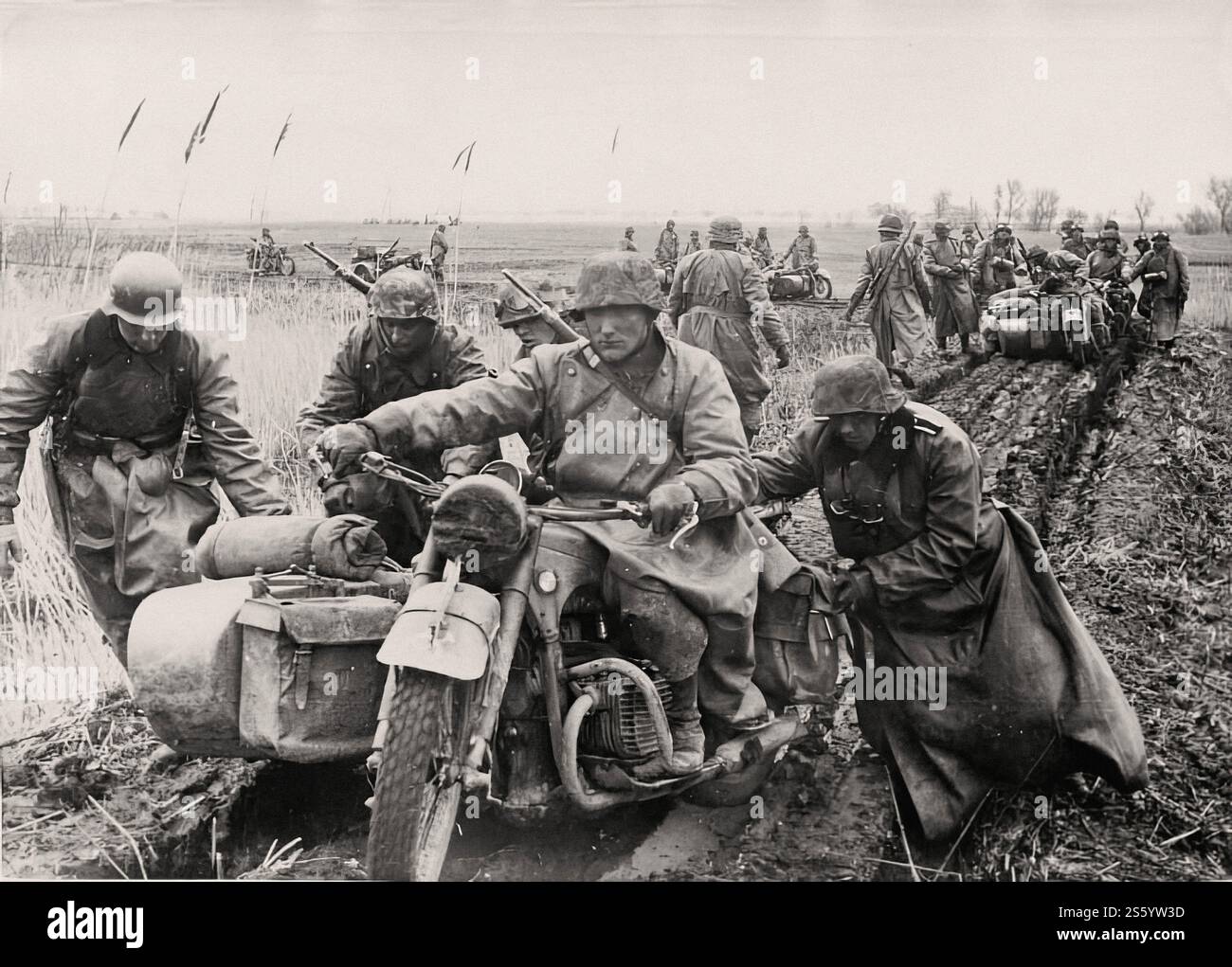 SS soldiers pushing the motorcycle out of the mud. - Historical ...