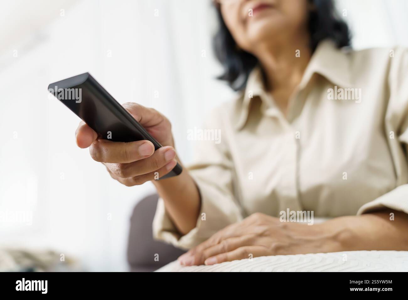 Elderly woman Watching smart TV and using remote controller Hand ...