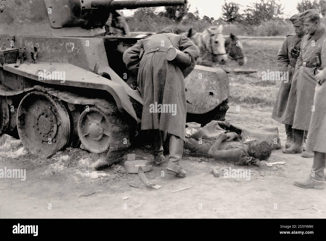 Wehrmacht soldiers inspecting dead crew member of the burned Soviet ...