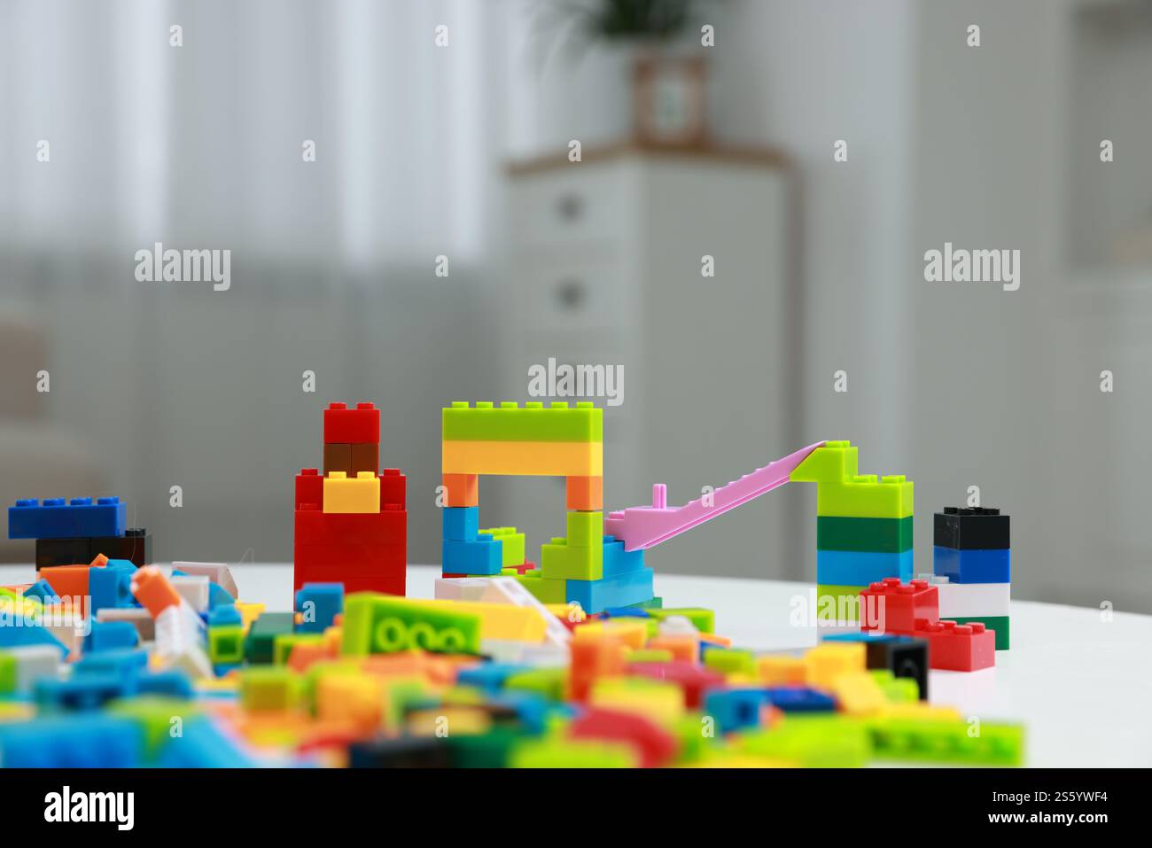 Construction toy. Figures made with building bricks and colorful blocks ...