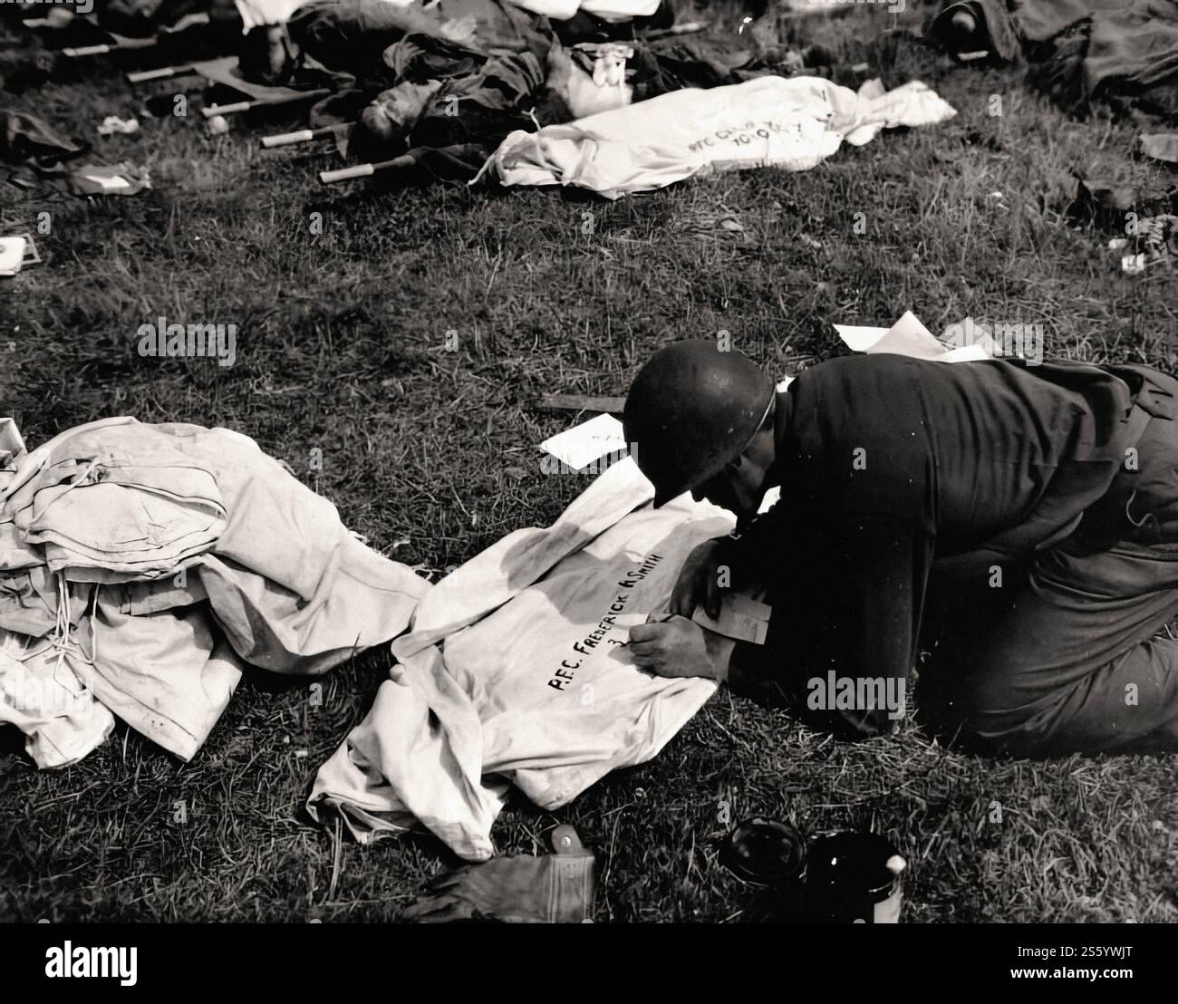 American soldier writing on the body bag for identification. In the ...