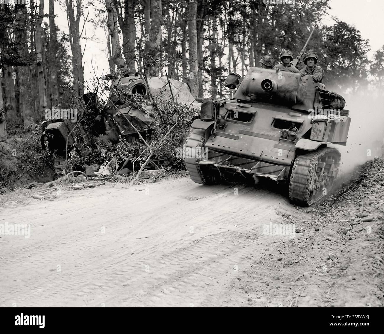 American soldiers on a 75-mm self-propelled howitzer M8 drive past ...