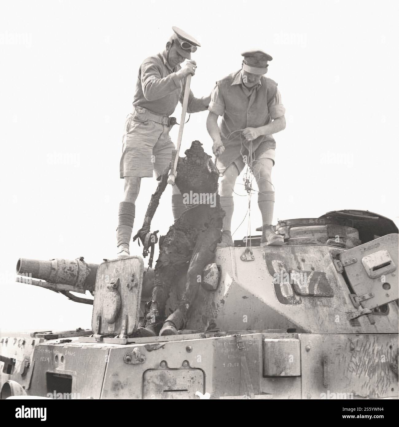 British soldiers removing the burning corpse of a member of a PzKpfw IV ...